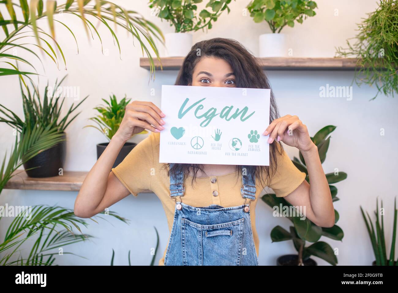 Woman with poster covering lower part of face Stock Photo - Alamy