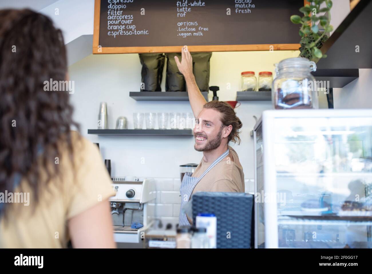 Joyful man pointing with hand to menu Stock Photo - Alamy