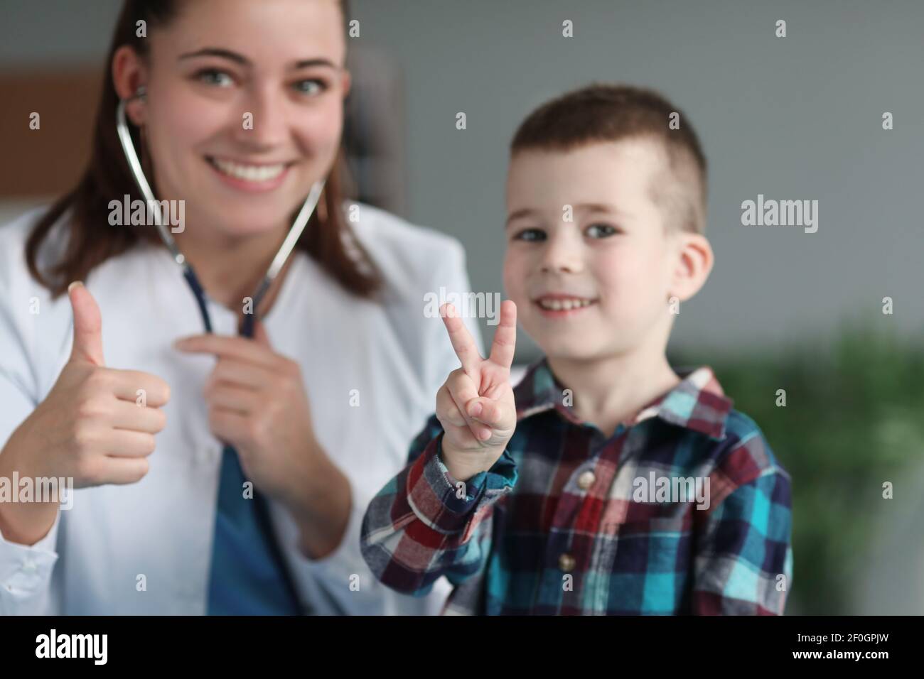 Young smiling doctor and child showing thumbs up closeup Stock Photo ...
