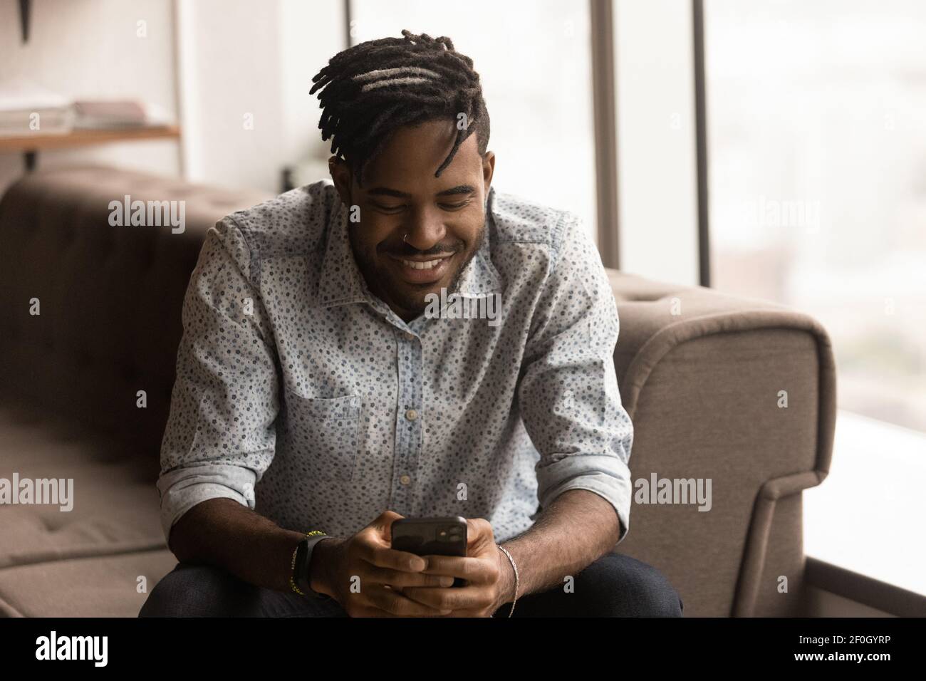 Positive black man browsing social hi-res stock photography and images ...