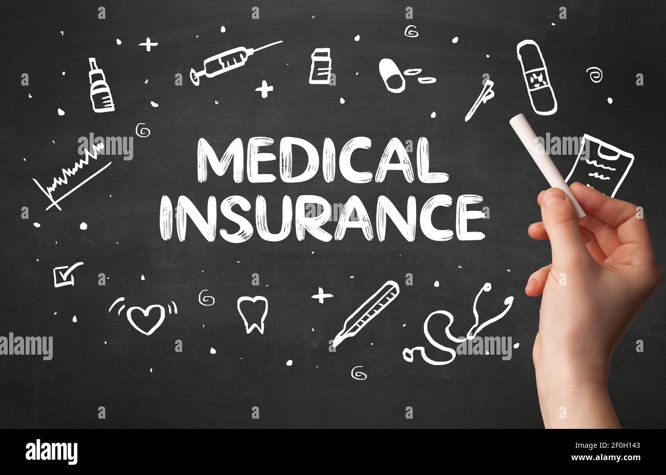 Hand drawing MEDICAL INSURANCE inscription with white chalk on ...