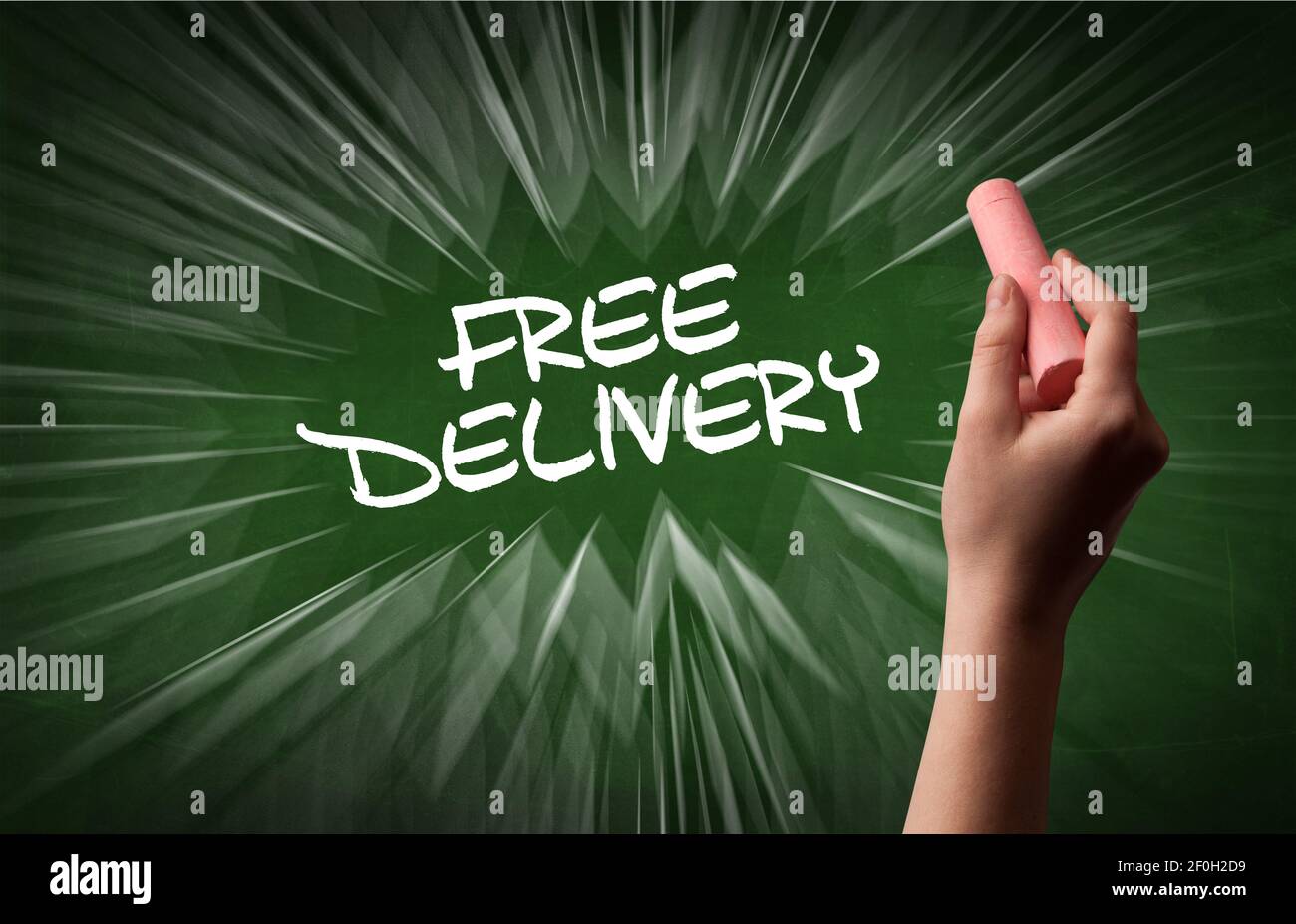 Hand drawing FREE DELIVERY inscription with white chalk on blackboard ...