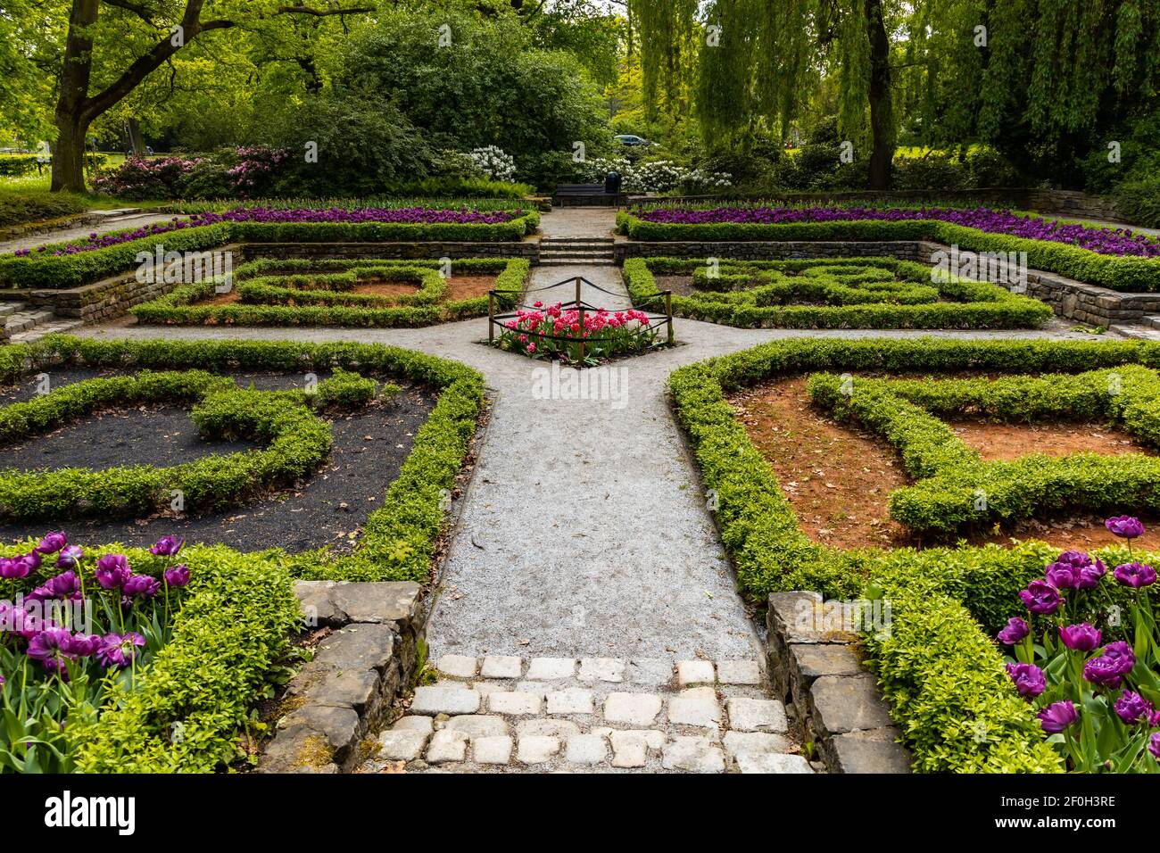 Small square in park with plants in card symbols shape Stock Photo - Alamy