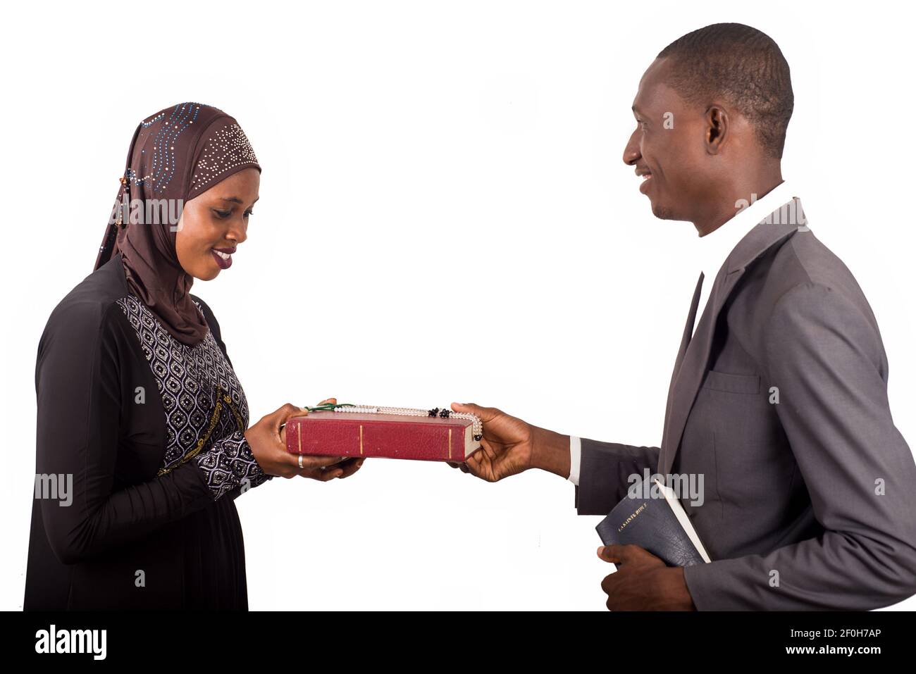 portraits of two smiling religious people holding a book on white ...