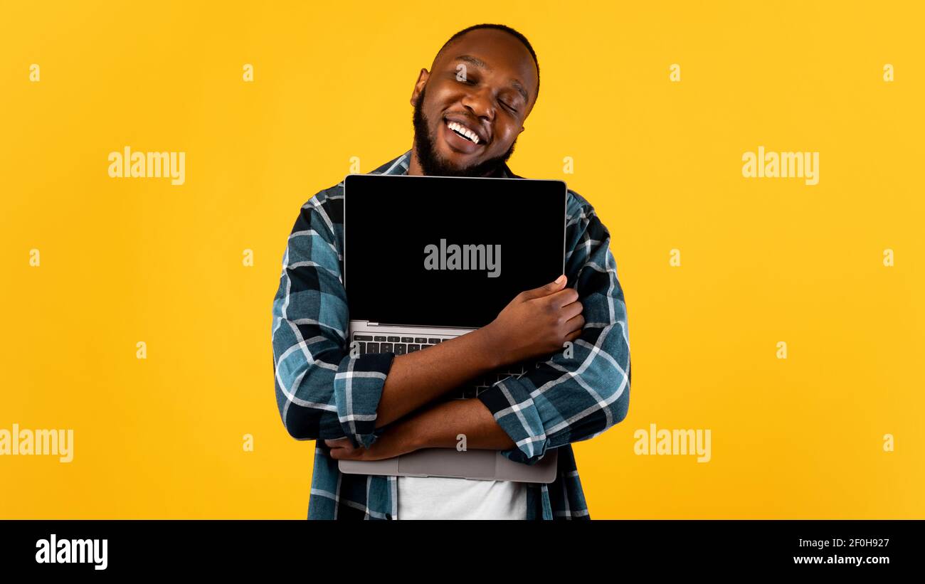 Black man laptop standing hi-res stock photography and images - Alamy