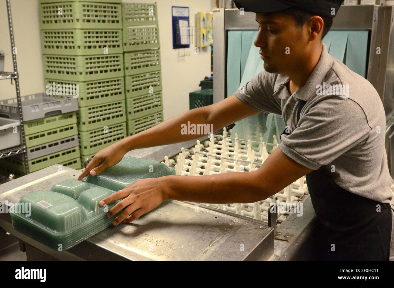 Antoni Fajaro, student from Los Angeles, washes re-usable go containers ...