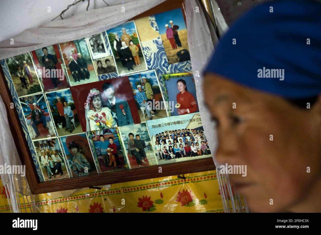 A Hui woman in front of family pictures. (Photo by Raphael Fournier ...