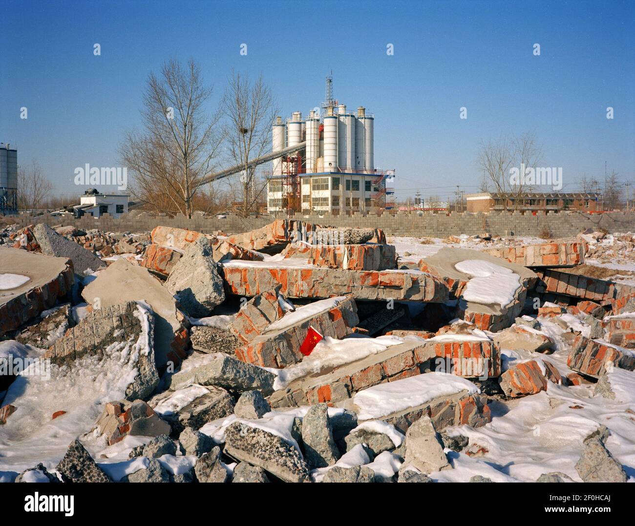 A Chinese flag amongst ruins of an artists village. (Photo by Raphael ...
