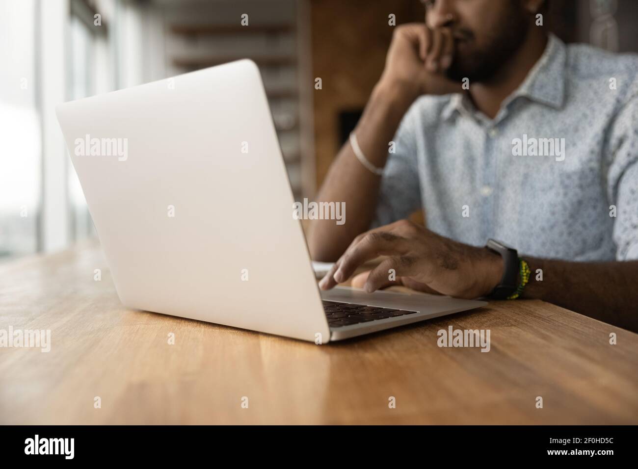 Close up thoughtful African American man using laptop, typing Stock ...