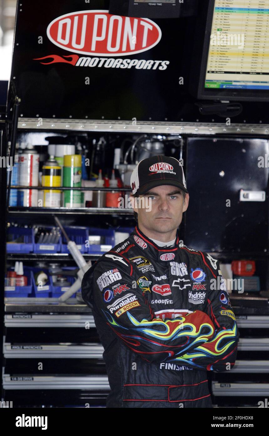 Jeff Gordon, driver of the Chevrolet (24), stands in his garage during ...