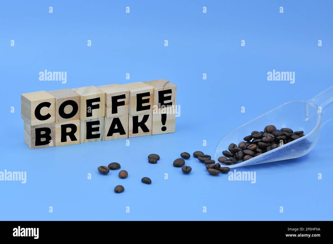 Layout of coffee beans on a scoop and wooden cube with text COFFEE ...