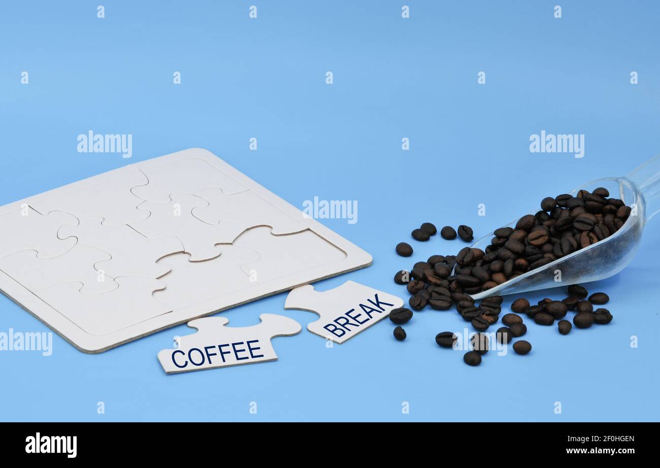 Layout of coffee beans on a scoop and jigsaw puzzle with text COFFEE ...