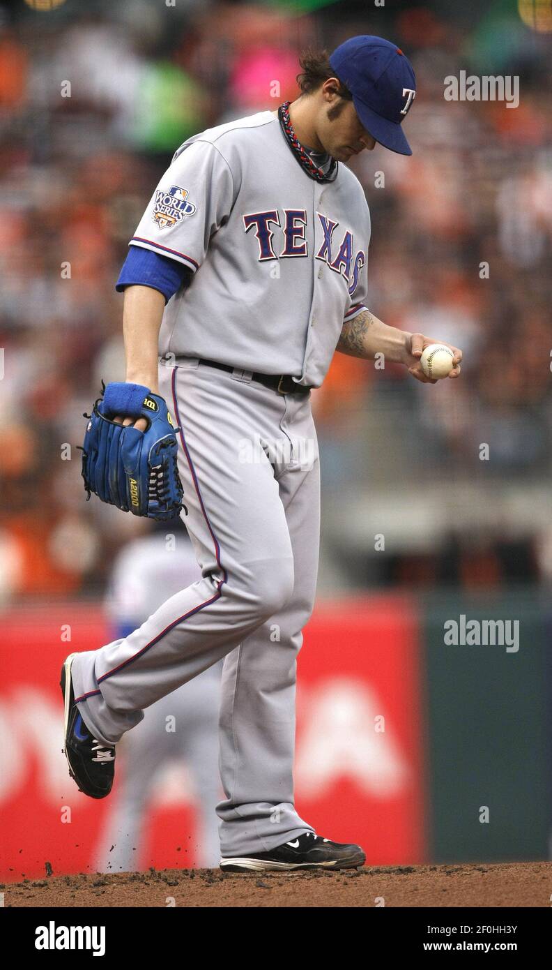 Texas Rangers pitcher C.J Wilson reacts after giving up a hit in second ...