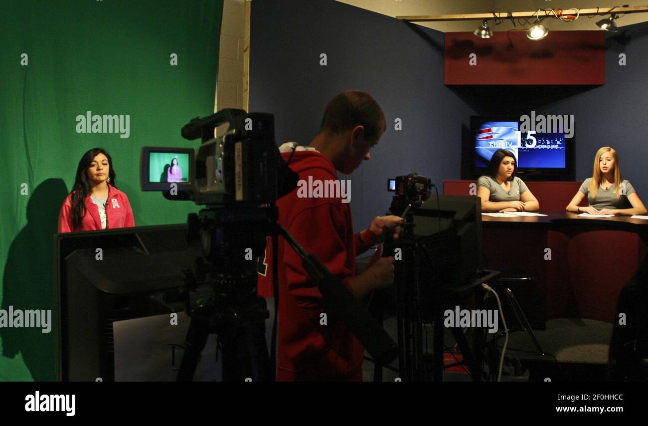 Chelsea Duchene, from left, waits to present the weather as Jake Wingo ...