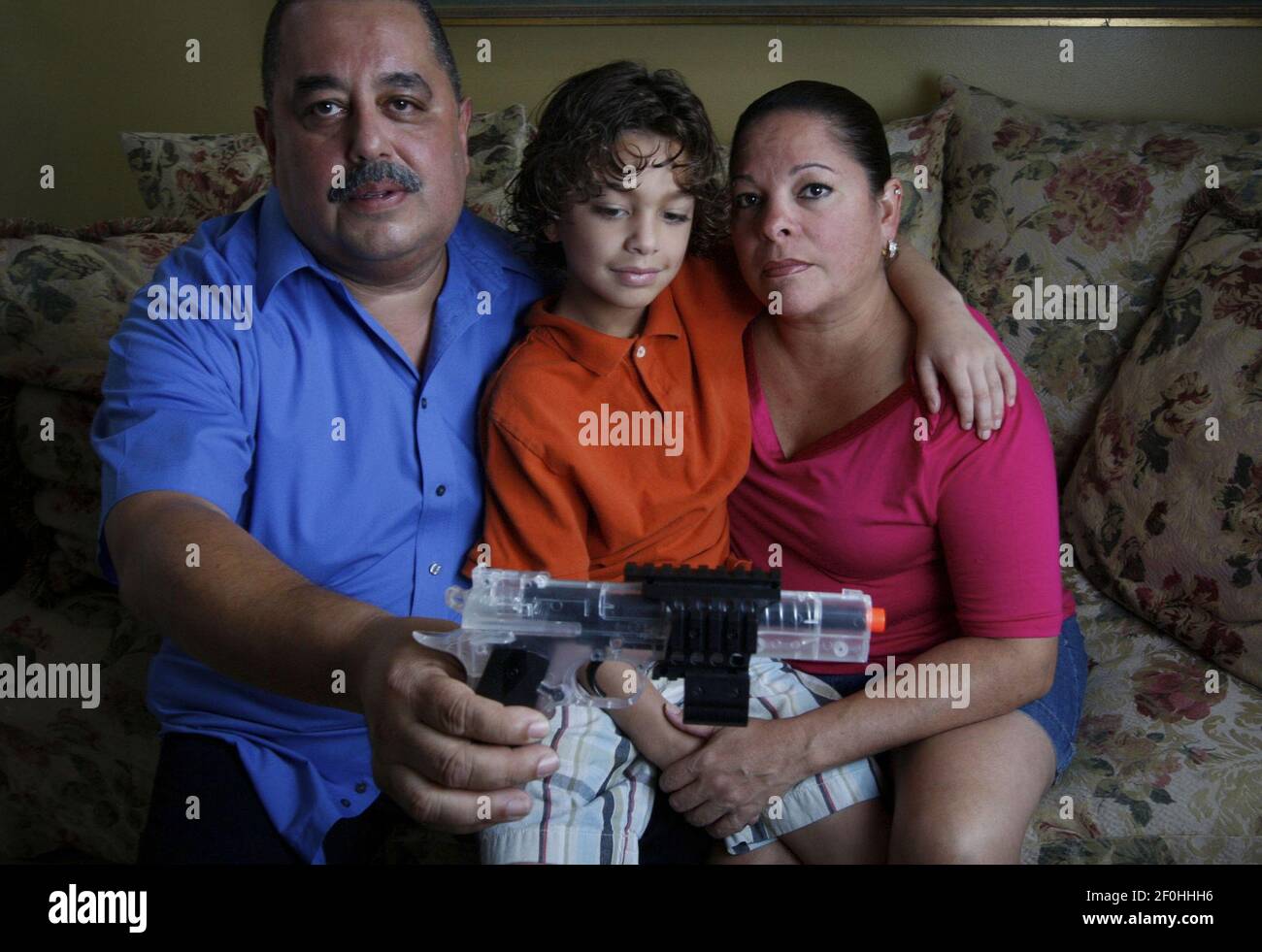 Samuel Burgos, 8, center, is pictured in his Miramar, Florida home with ...
