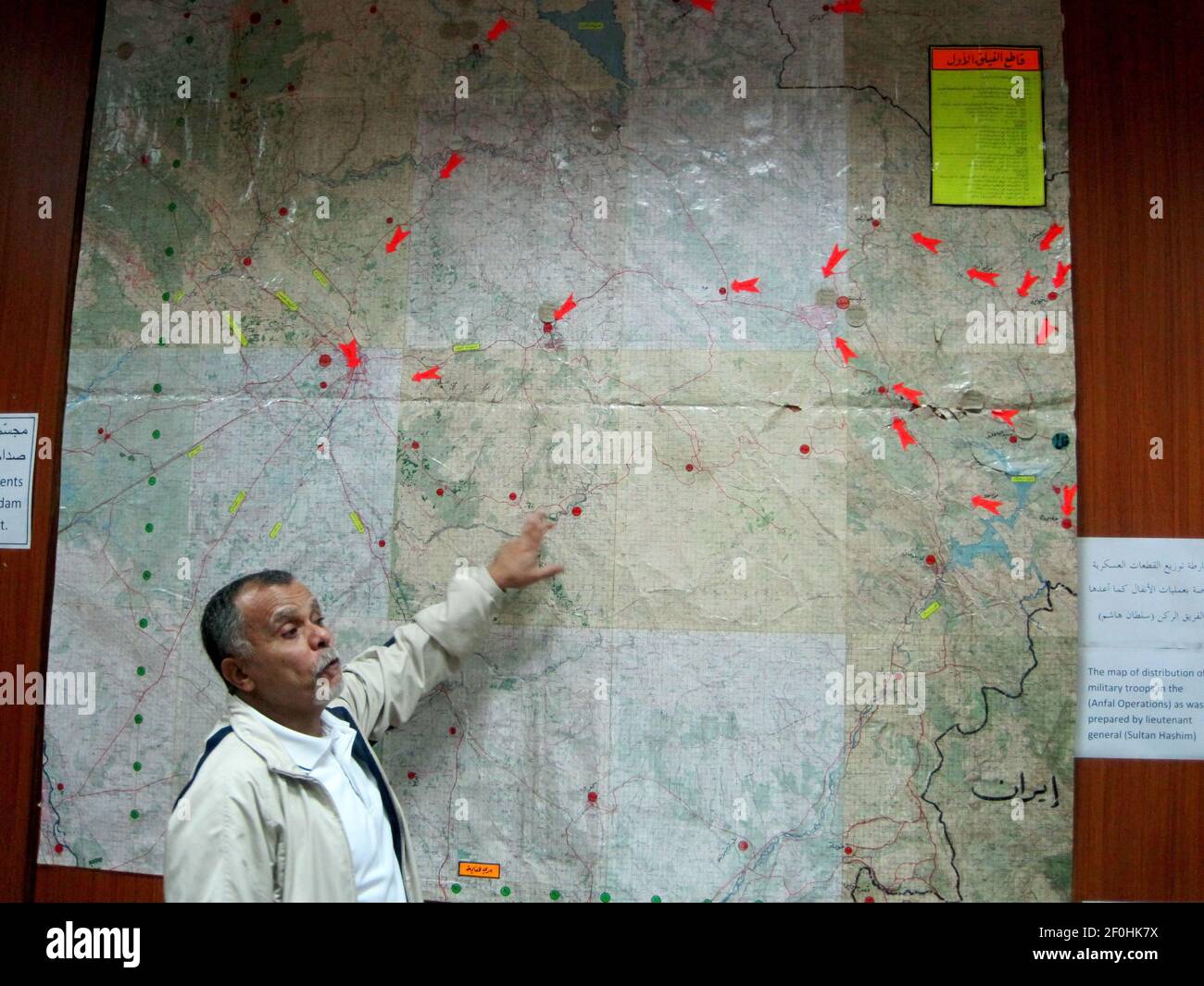 A guide points to a map used by Iraqi military commanders to plan the ...