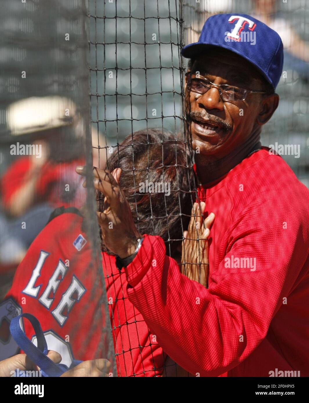 Texas Rangers manager Ron Washington, right, rates a hug from a fan ...
