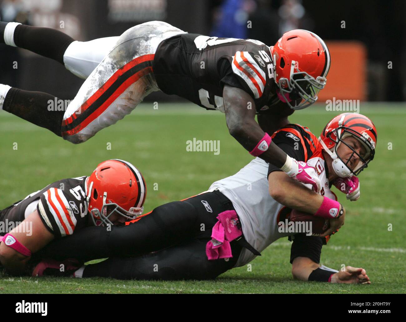 Cleveland Browns Marcus Benard, top, and Matt Roth sack Cincinnati ...