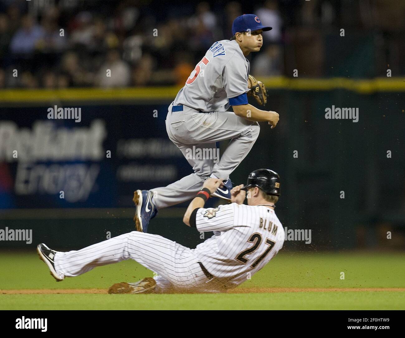 Chicago Cubs shortstop Darwin Barney (15) leaps over a sliding Geoff ...