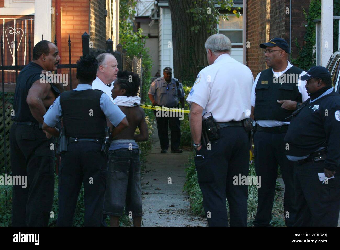 Chicago police officers investigate the scene where a 12-year-old boy ...