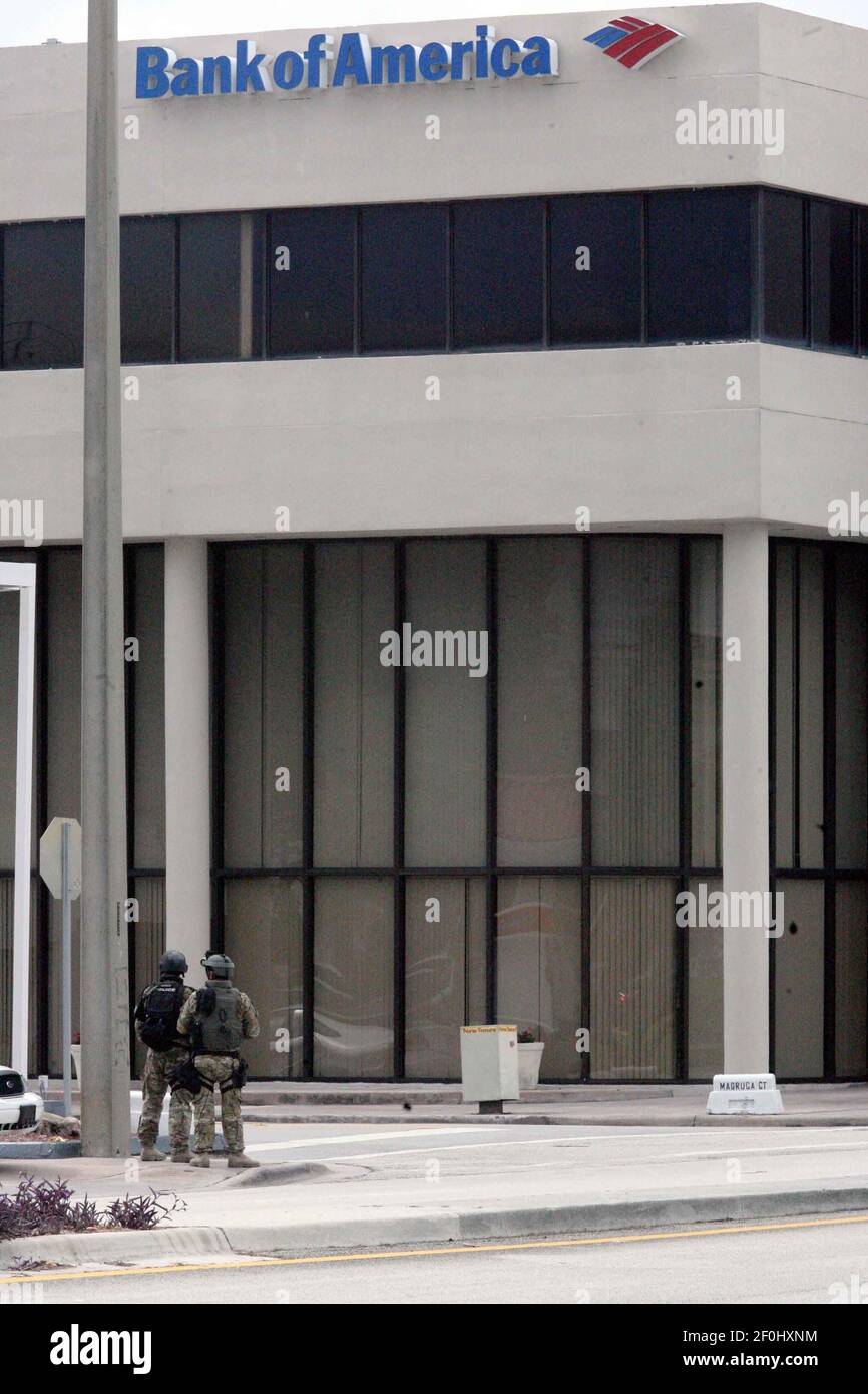 SWAT team members stand outside the Bank of America at 1500 South Dixie ...