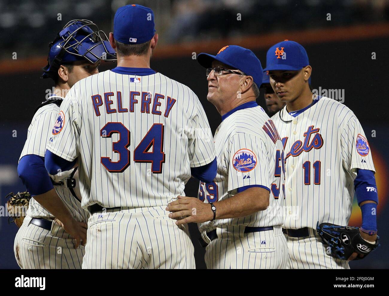 Pitching coach Dan Warthen of the New York Mets talks with pither Mike ...