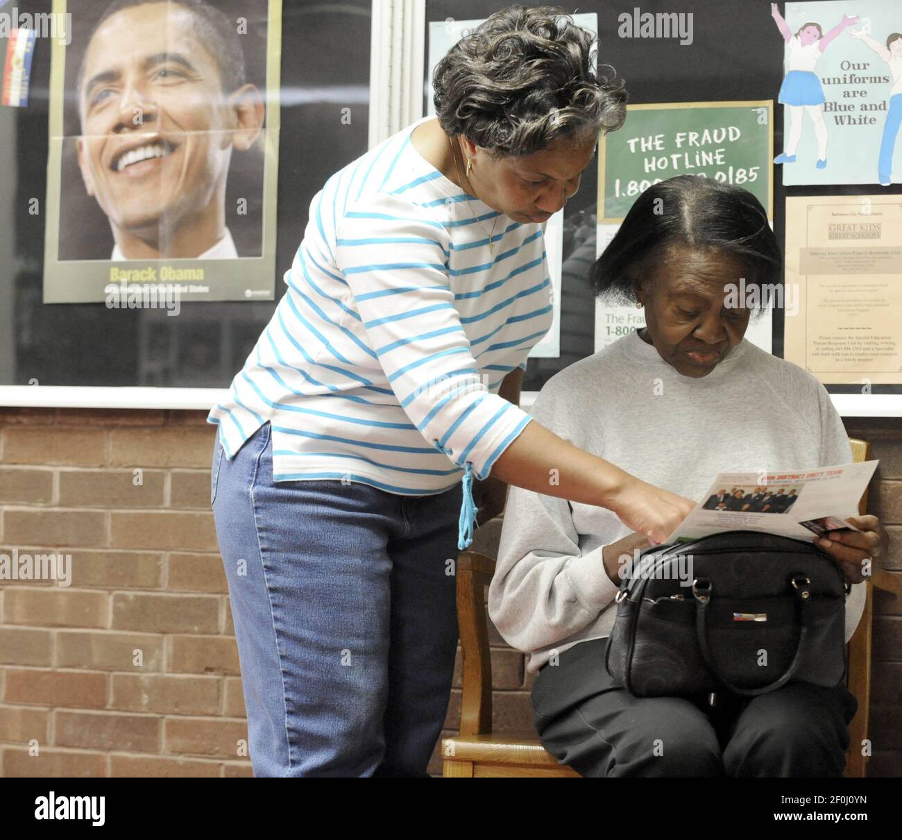 Ernestine Gause assists her mother, Lucy Curbeam as she looks over the ...