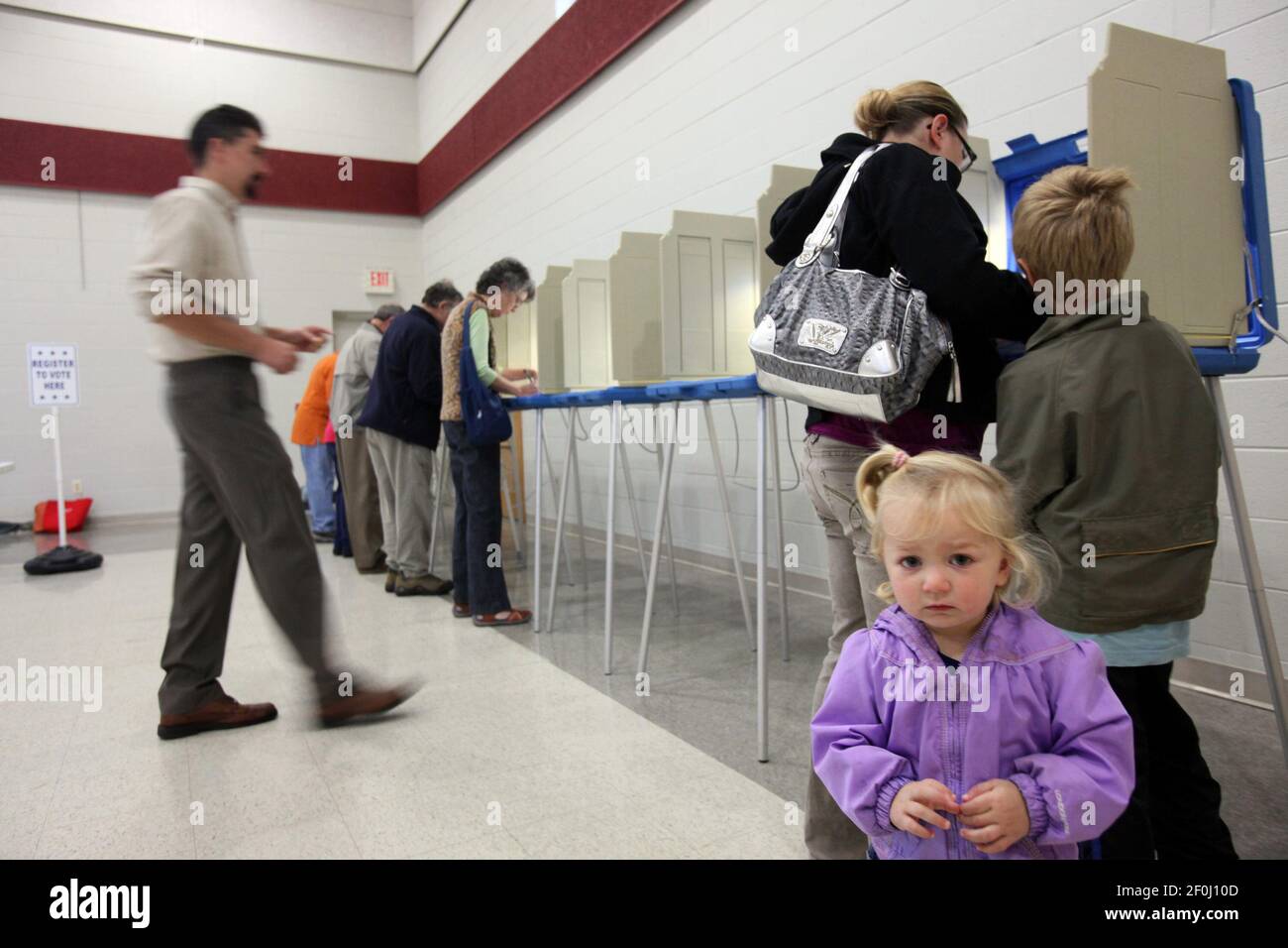Two-year-old Julianne watches the crowd as her mother, Laura Drews ...