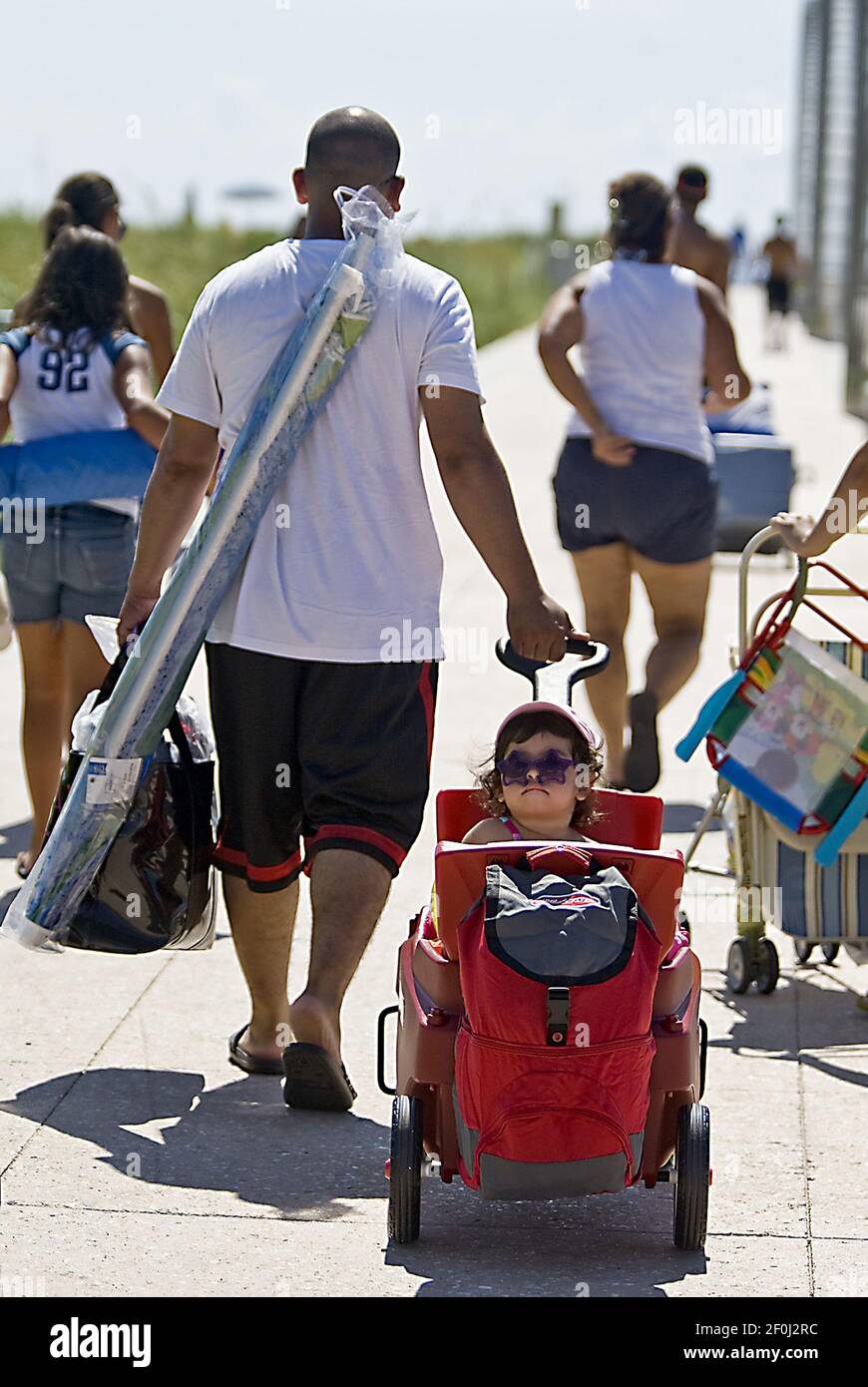 Victor Vasquez tows his daughter Samantha Vasquez out to South Beach ...