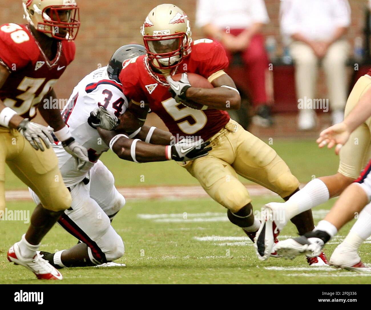 Florida State punt returner Greg Reid (5) shoves aside Samford ...