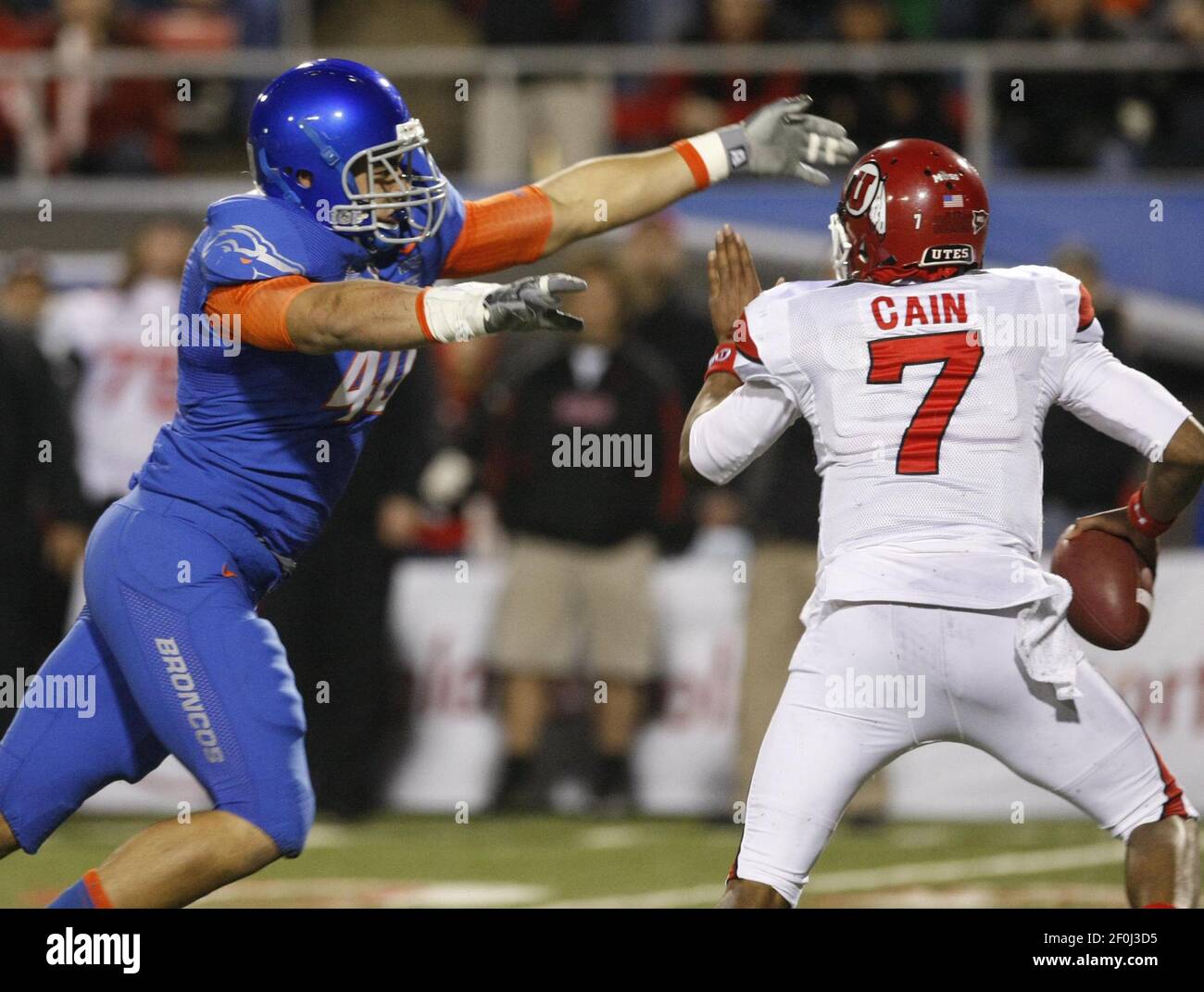 Boise State defesive end Tyrone Crawford, left, rushes Utah quarterback ...