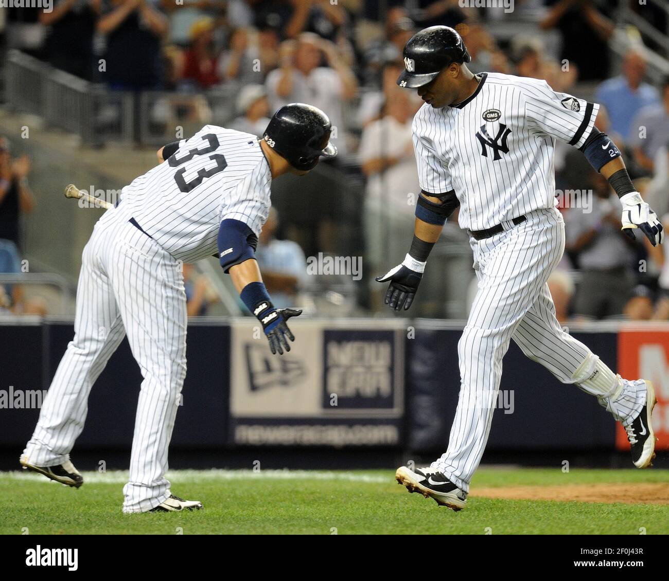New York Yankees' Nick Swisher (33) congratulates Robinson Cano on his ...
