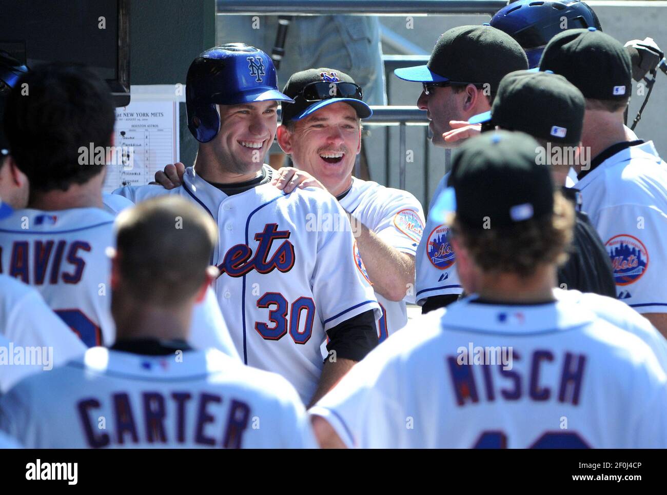 New York Mets catcher Josh Thole (30) is congratulated by his teammates ...