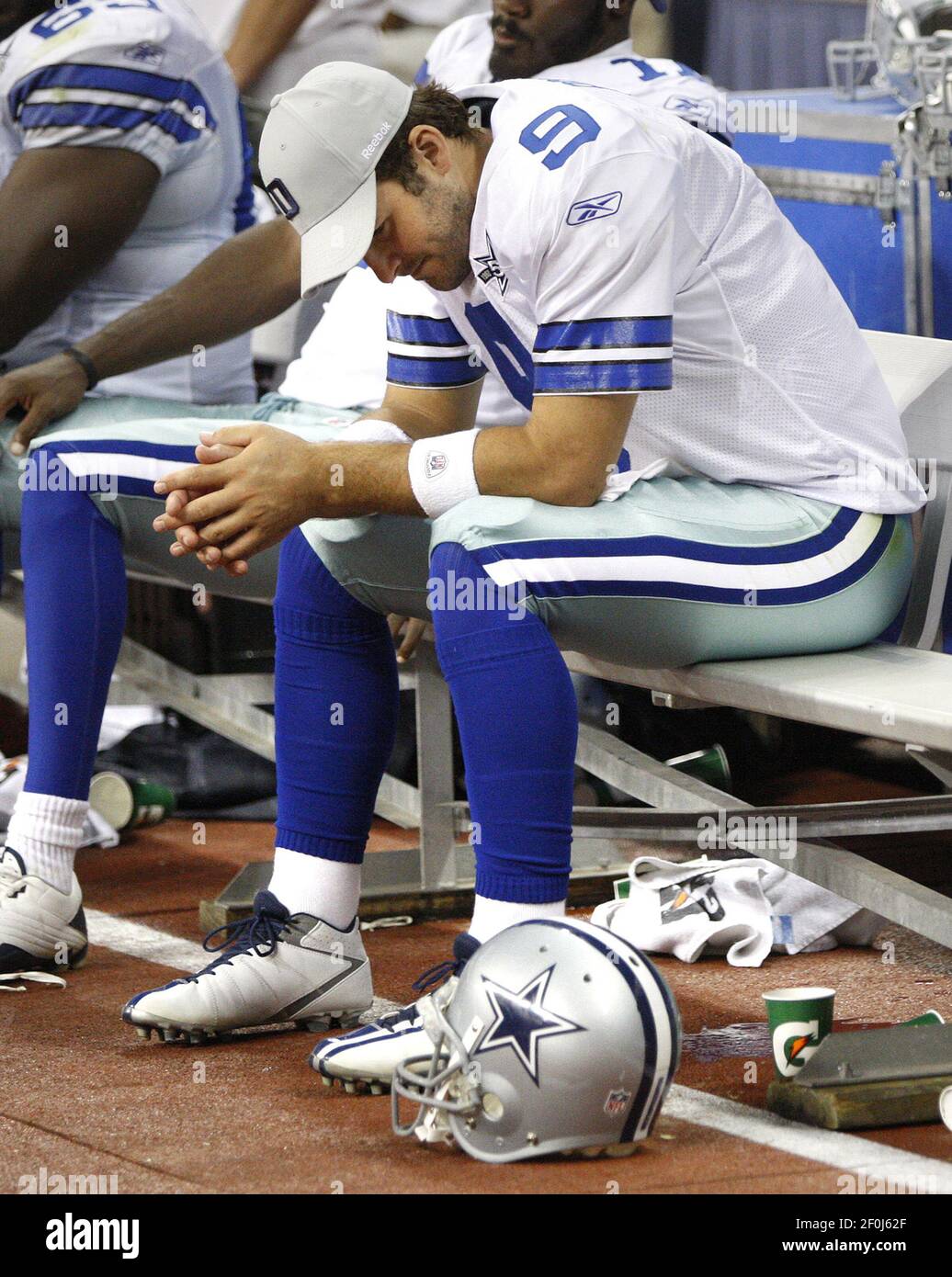 Dallas Cowboys quarterback Tony Romo, hangs his head on the bench amid ...
