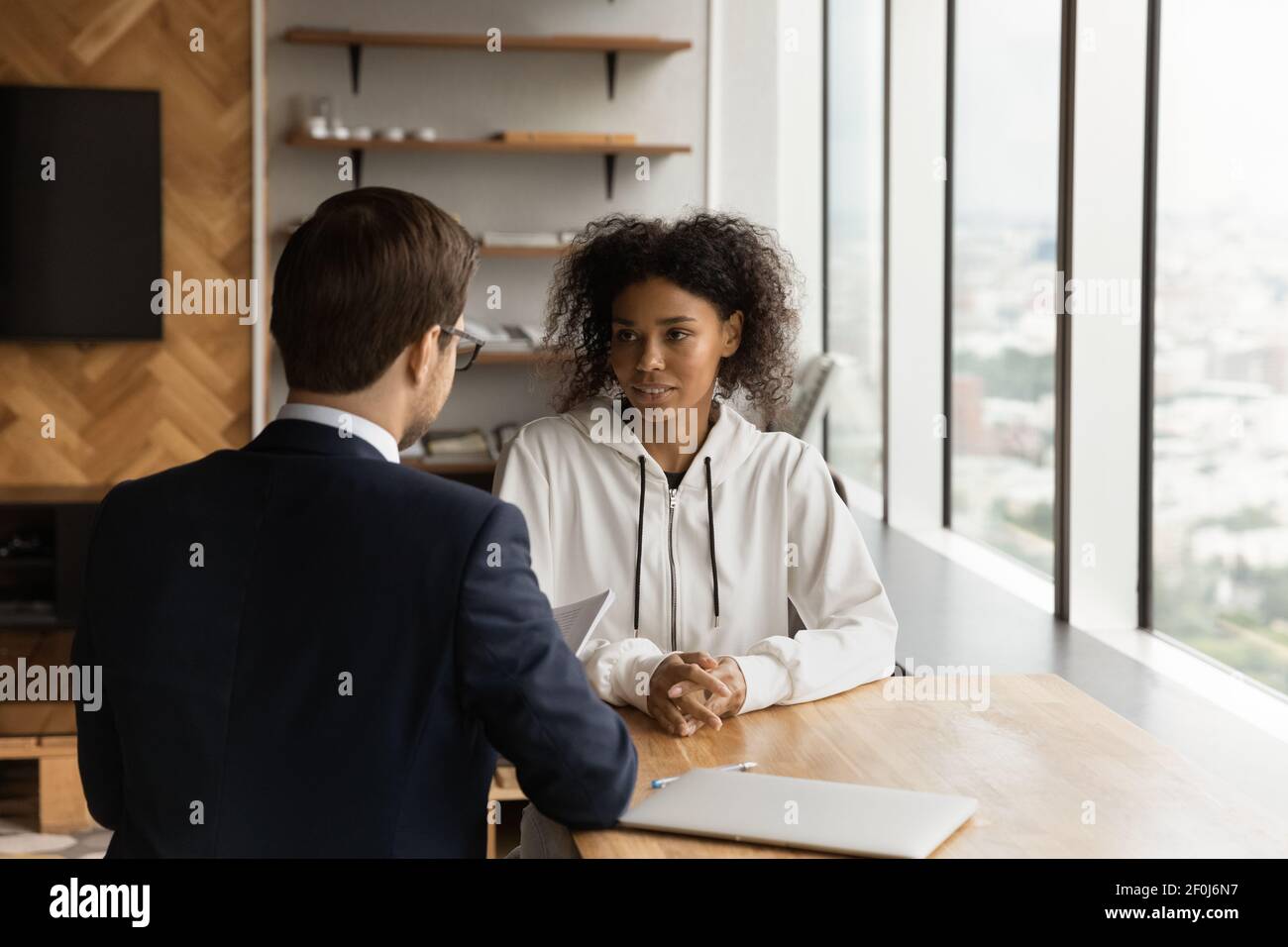 Rear view Caucasian hr manager interviewing confident African American ...