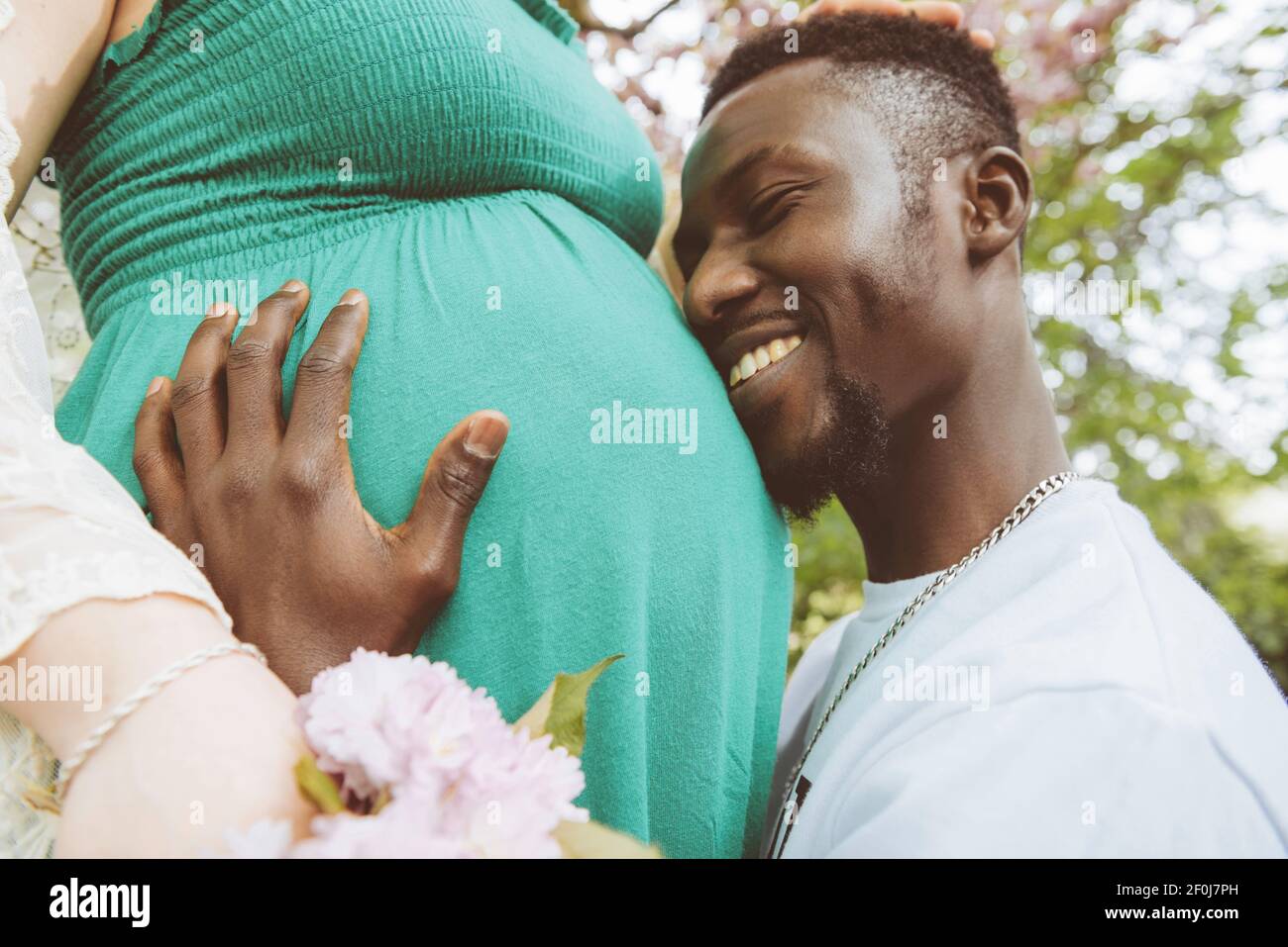Pregnant couple - father hugging mommy bump Stock Photo - Alamy