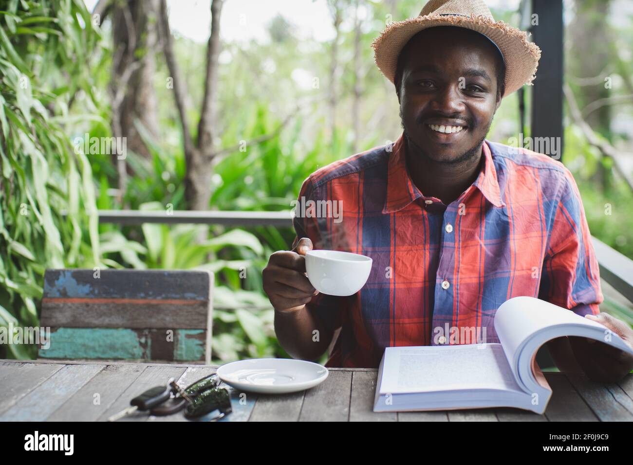 African man reading a book hi-res stock photography and images - Alamy