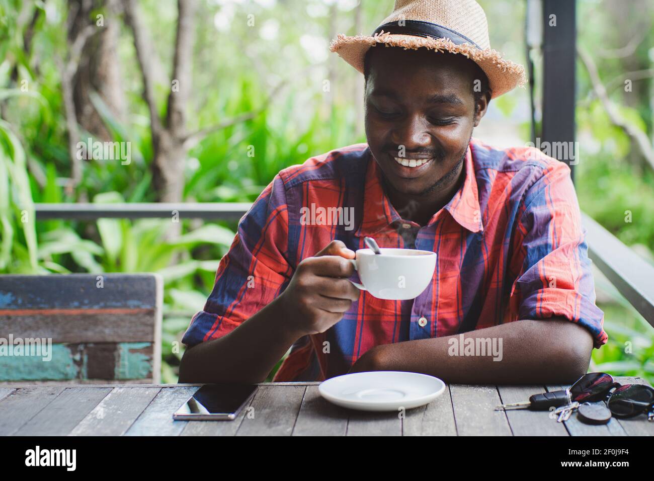African man holding a hot of coffee with smile and happy Stock Photo ...