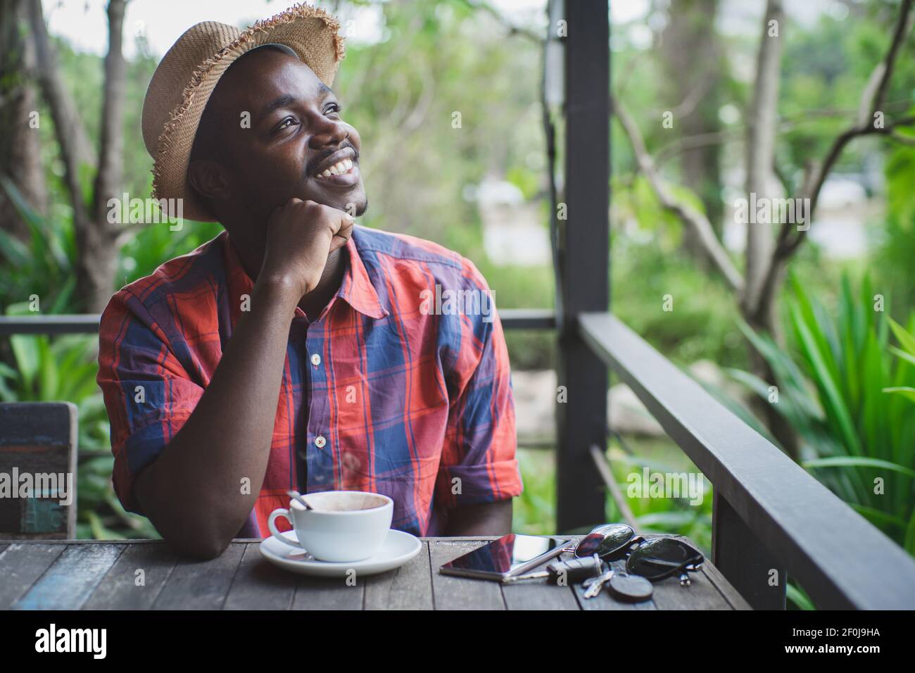African man thinking with a hot of coffee Stock Photo - Alamy