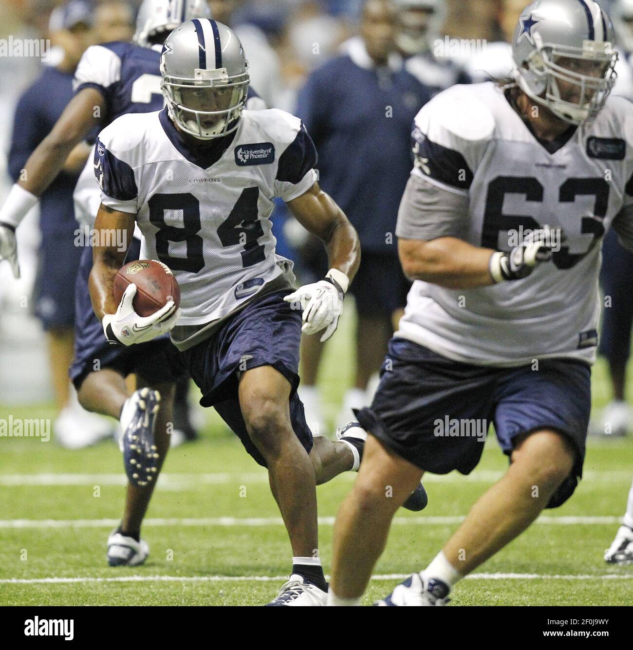 Patrick Crayton, left, follows the block of Kyle Kosier (63) as the ...