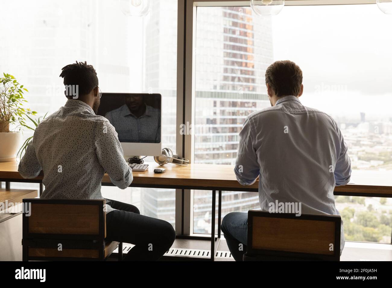 Back view diverse colleagues employees sitting at desk in office Stock ...