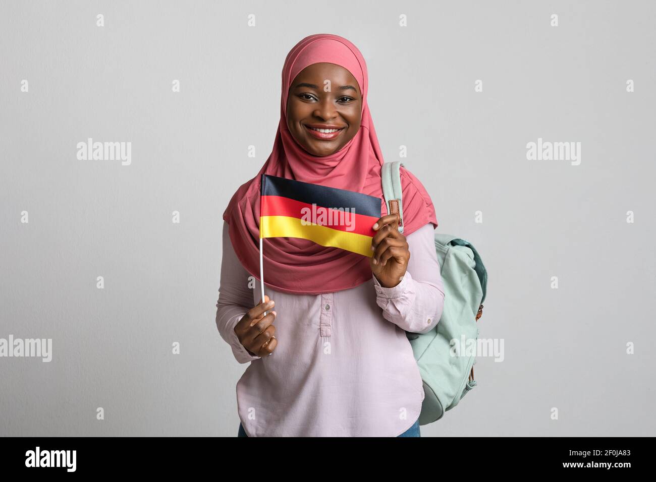 Pretty muslim lady student holding German flag Stock Photo - Alamy