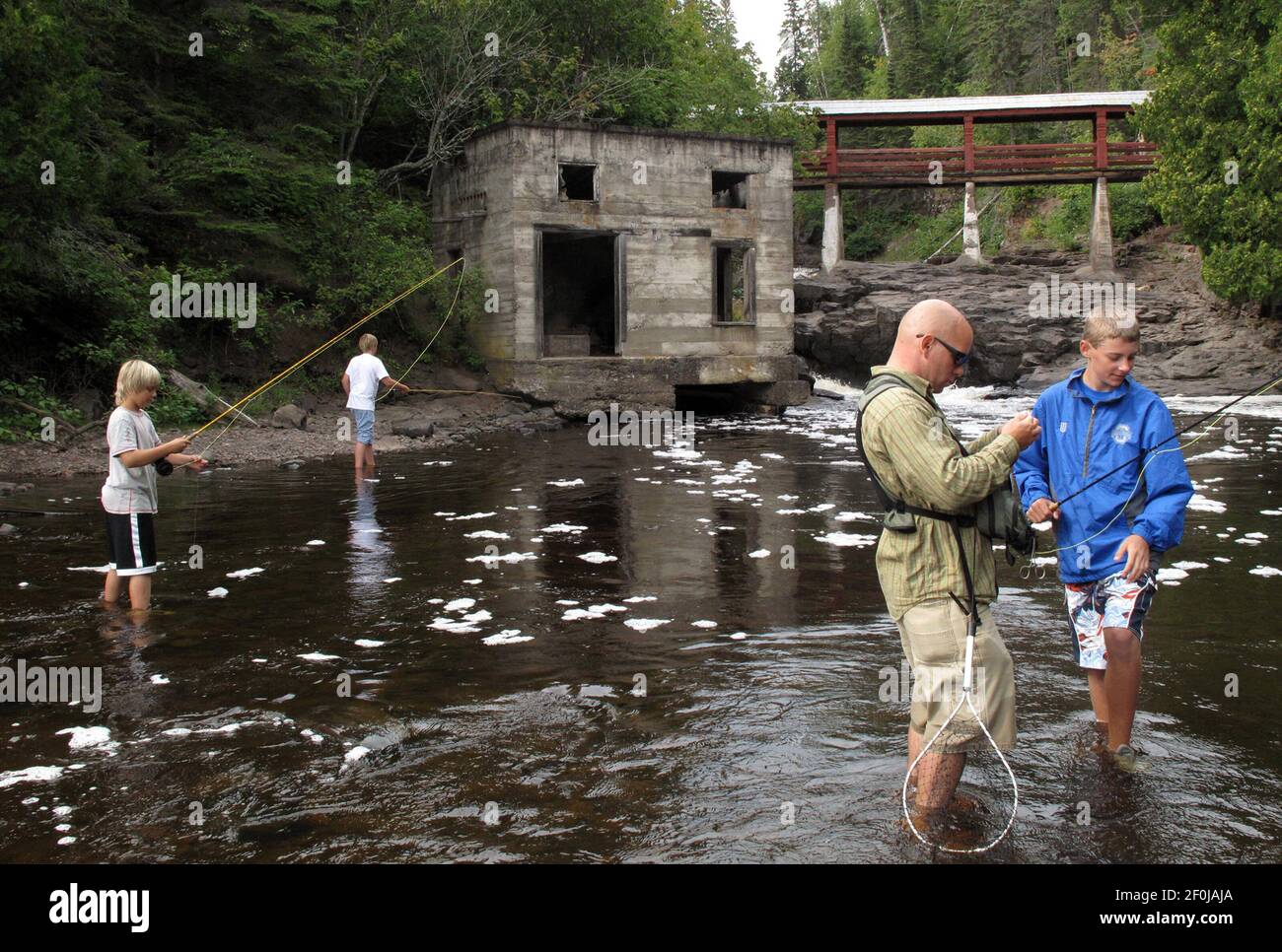 Chayse Buchta (left) and cousin, Joey Buchta, take a flyfishing lesson ...