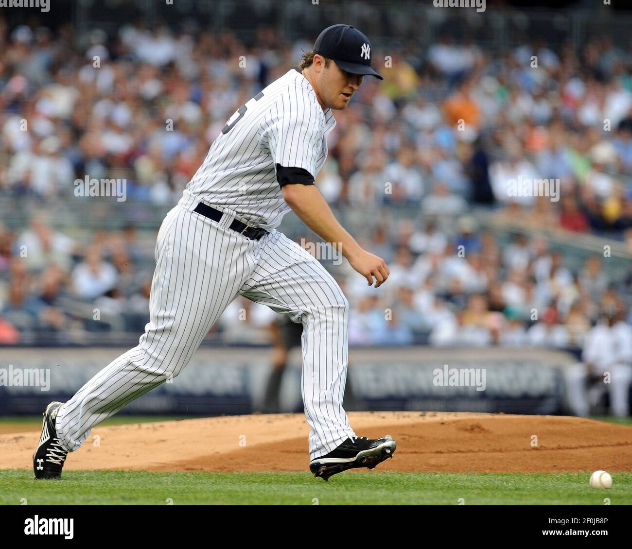 New York Yankees' Phil Hughes chases a comebacker by Los Angeles Angels ...