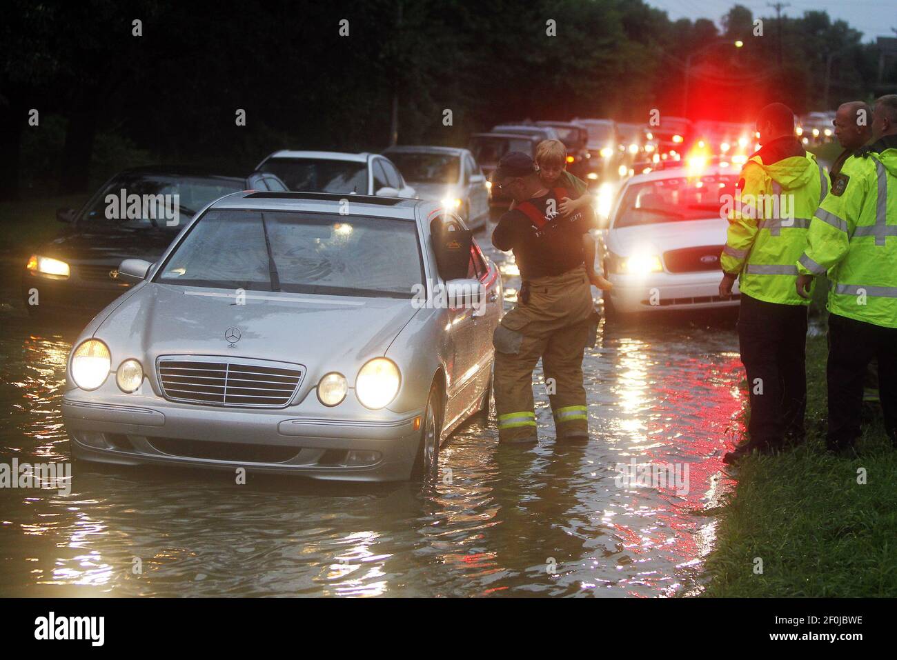 Lexington Fire Department firefighter Harry Gilbert, center, carries 5 ...