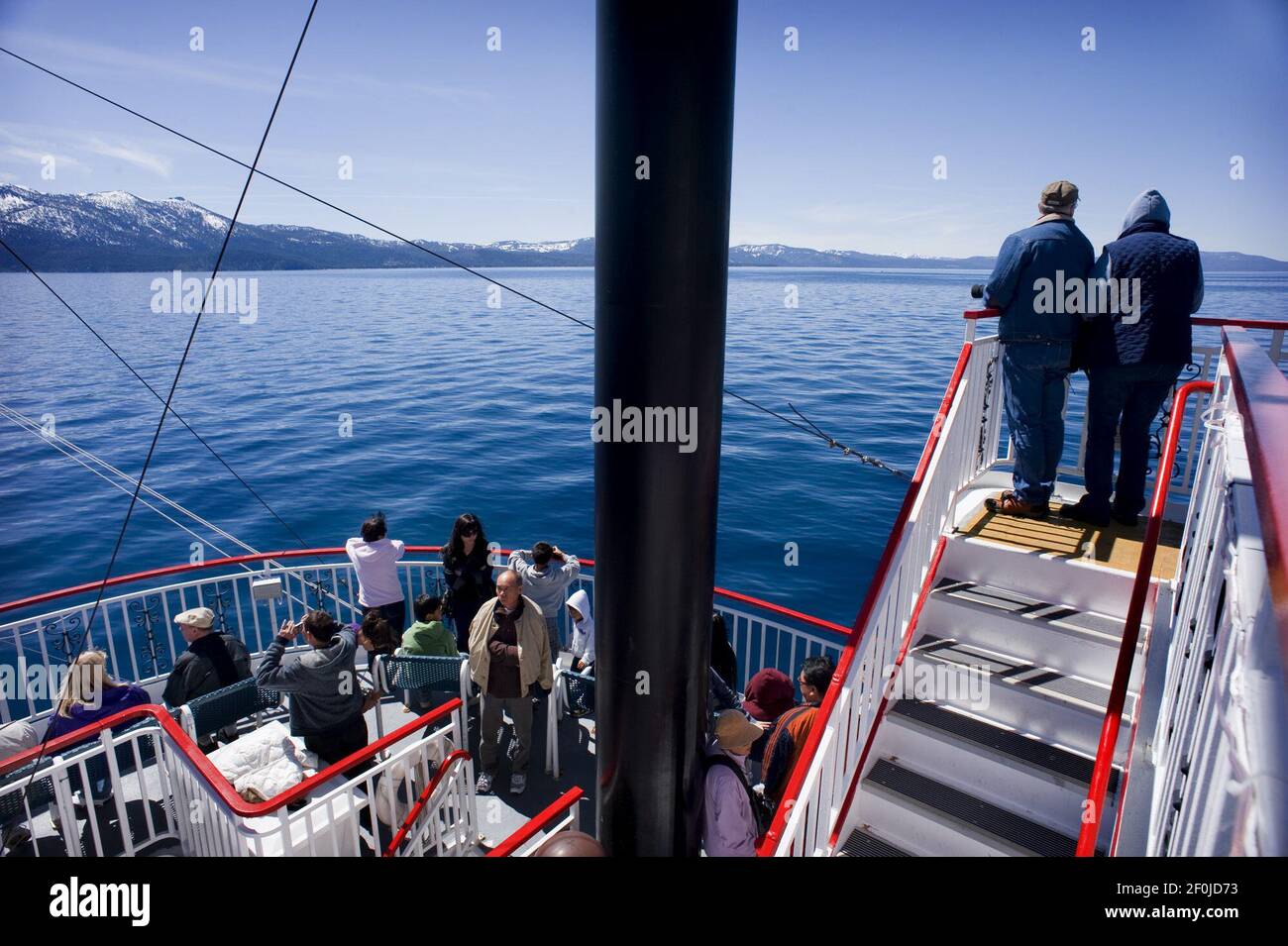Visitors take in the phenomenal view of Lake Tahoe on a paddleboat ...
