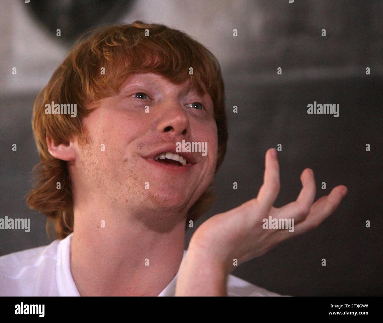Rupert Grint, who portrays Ronald Weasley, talks with reporters as ...