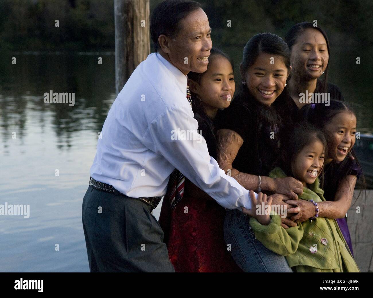 Chu Vo poses with his five daughters during a family photo shoot ...