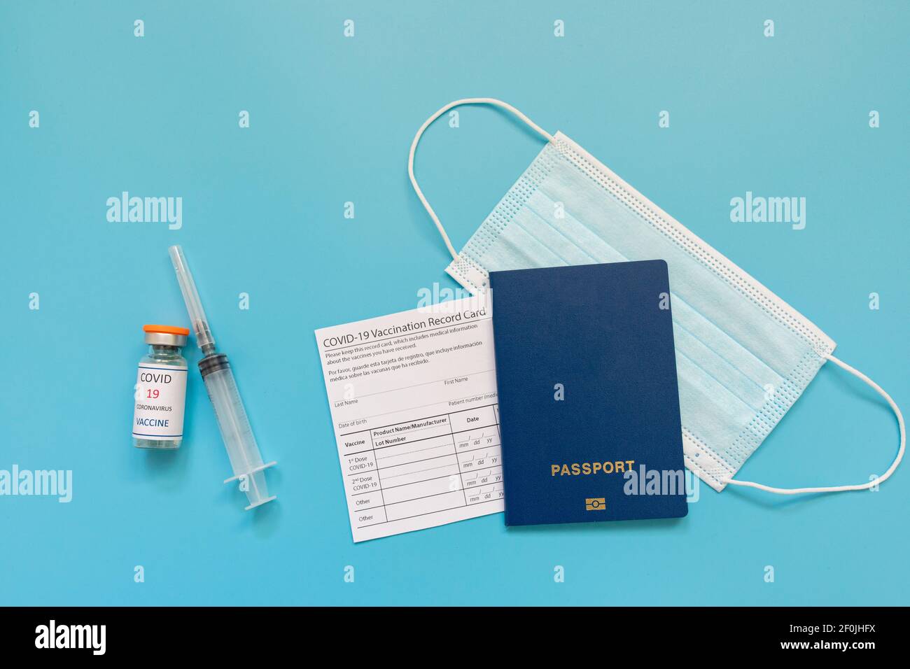 Doctor is holding a vaccination record card and corona virus vaccine ...