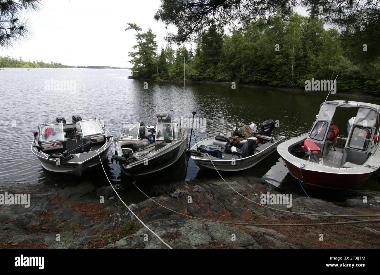 Boats are tied up on one of the many islands for lunch on Lake of the ...